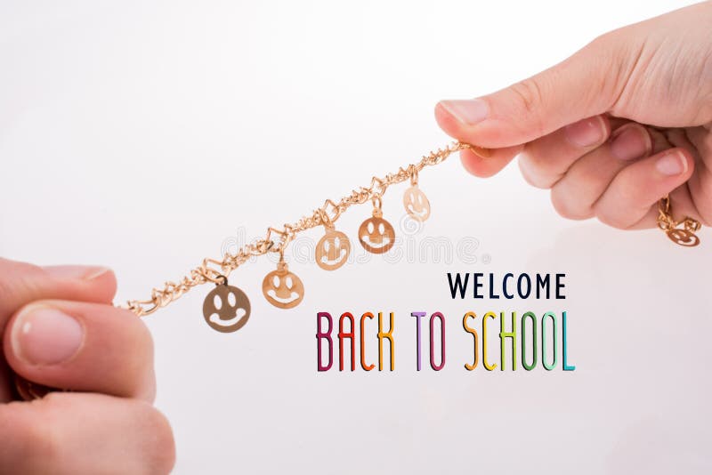 Smileys on a chain in hand stock photo. Image of golden - 156978284