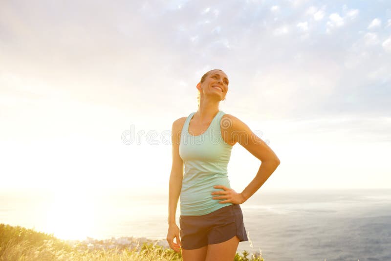 Smiling Active Woman Standing Outside during Sunset Stock Photo - Image ...
