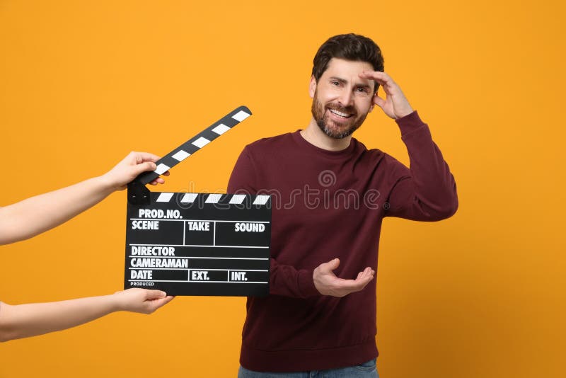 Smiling Actor Performing while Second Assistant Camera Holding ...