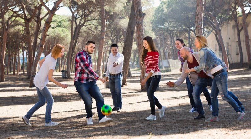 Friends Chasing Each Other in a Sunny Park, Enjoying a Playful and ...