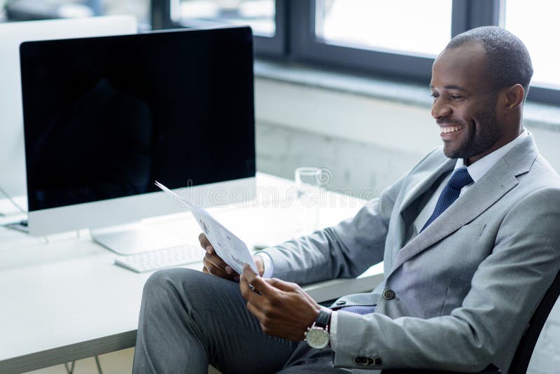 Smiling African American Businessman Reading Newspaper Stock Photo ... Smiling African American Businessman Reading Newspaper Stock Photo ...