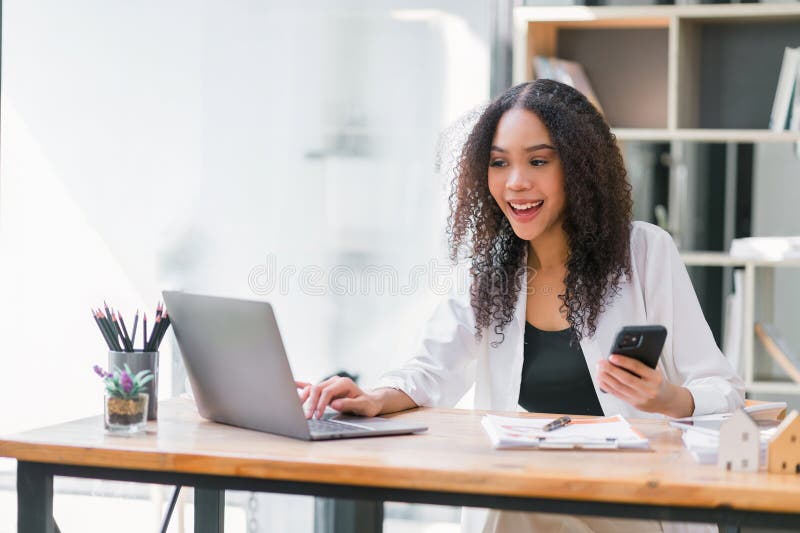Smiling African American Businesswoman Using Smartphone at Work. Stock ...