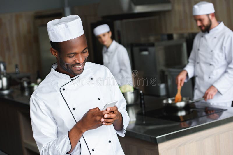 Smiling African American Chef Using Smartphone Stock Image - Image of ...