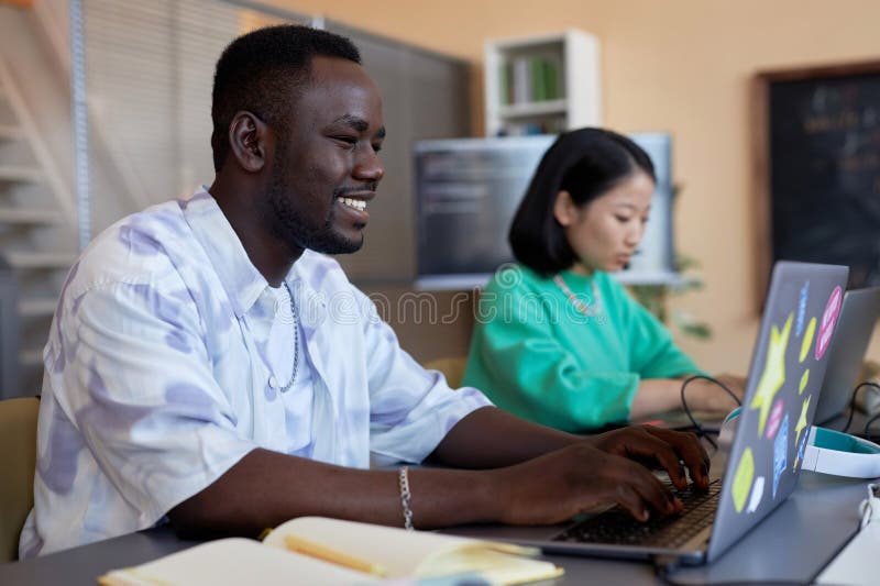 Smiling African American Guy Typing on Laptop Keyboard at Informatics ...