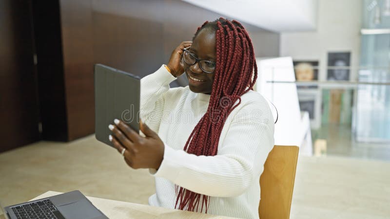 Smiling African American Woman with Braids Using Tablet in Modern ...