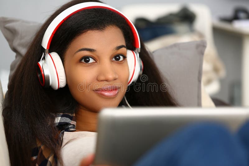 Smiling African American Woman In Headphones With Laptop Sitting On