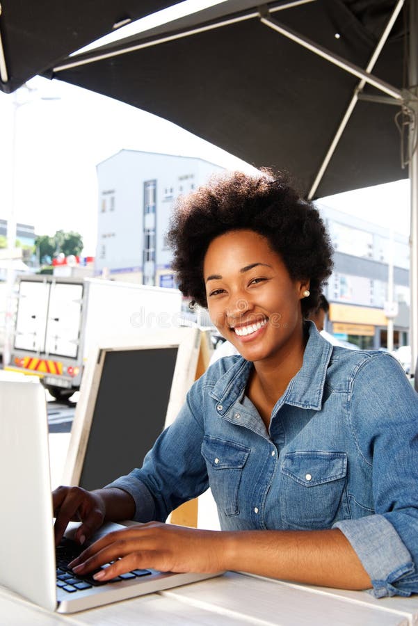 Smiling African Lady Working on Computer at Outdoor Cafe Stock Image ...