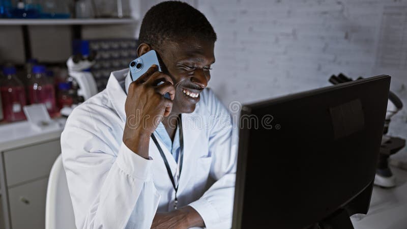 Smiling African Man in White Lab Coat Talking on Phone in Laboratory ...