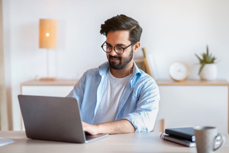 Smiling Arab Man Self-Entrepreneur Working with Laptop at Home Office ...