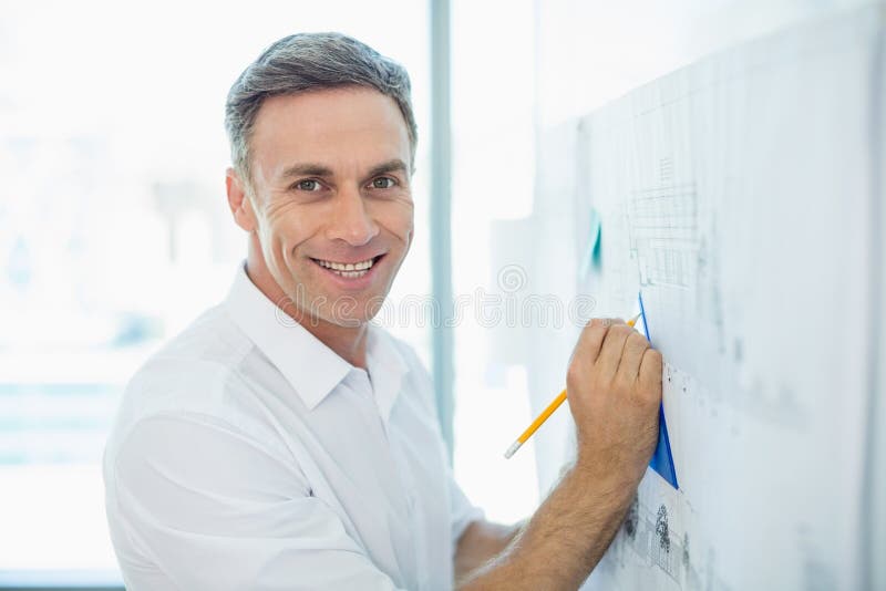 Smiling Architect Drawing on Blueprint at Whiteboard Stock Photo ...