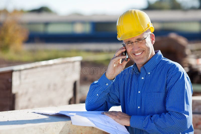 Construction Worker On Building Site Using Mobile Phone Stock Image ...