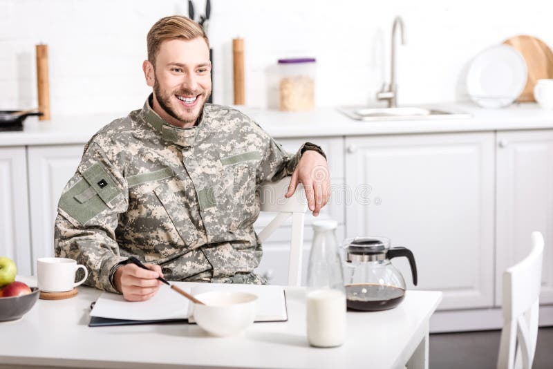 Smiling Army Soldier Sitting at Kitchen Table and Stock Image - Image ...