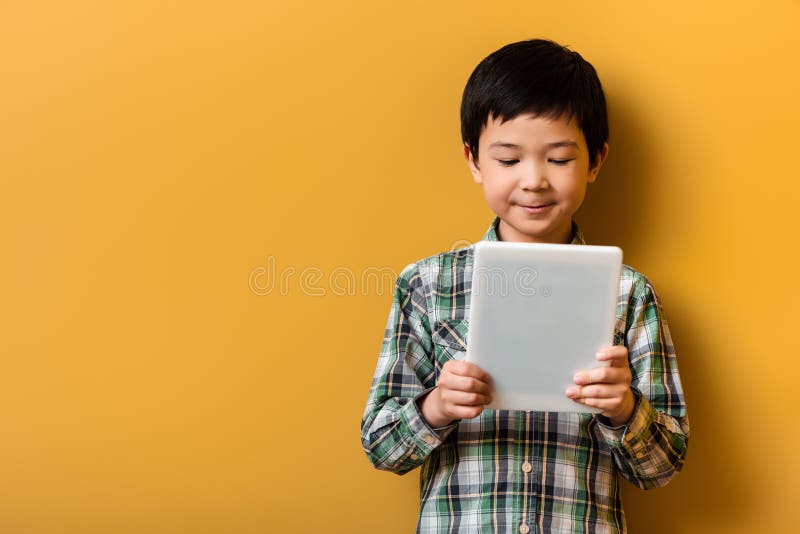 Smiling Asian Boy Using Digital Tablet Stock Photo - Image of emotional ...