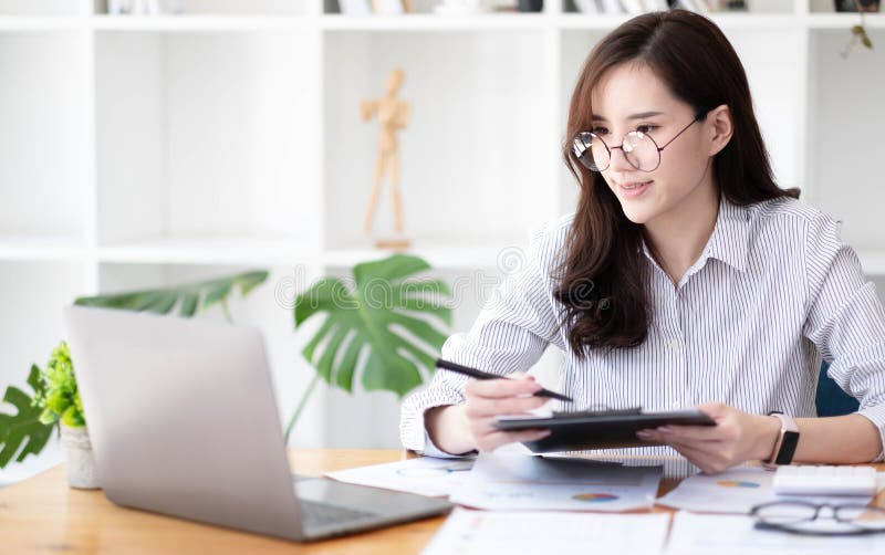 Smiling Asian Business Woman Sitting in a Modern Office. Stock Photo ... Smiling Asian Business Woman Sitting in a Modern Office. Stock Photo ...