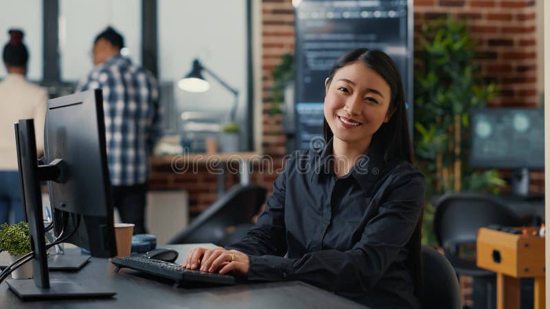 Smiling Asian Database Software Developer Writing Programming Code On Computer Keyboard Stock