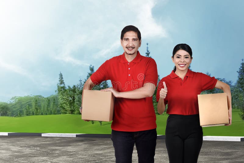 Smiling Asian Delivery Service Team with the Package Stock Photo ...