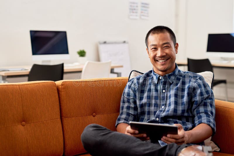 Smiling Asian Designer Using on a Digital Tablet at Work Stock Image ...