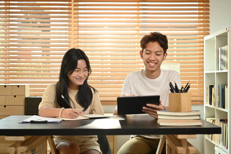 Smiling Asian Male Private Tutor Helping Young Student with Homework ...