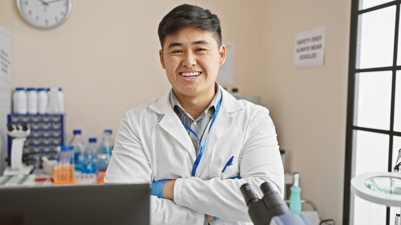 Smiling Asian Man in Lab Coat Posing in a Modern Laboratory with ...