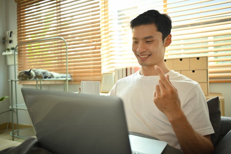 Smiling Asian Man Making Video Call on Laptop, Talking and Gesturing ...