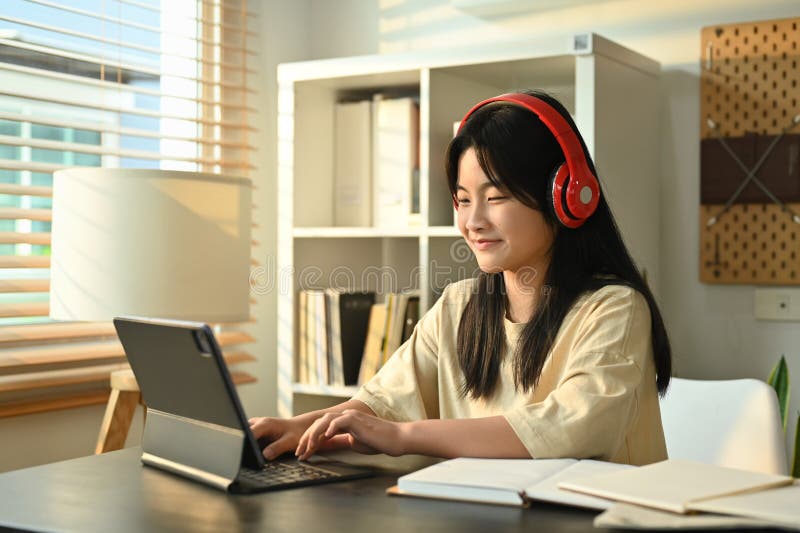 Smiling Asian Student Girl Wearing Headphone Watching Online Tutorial ...