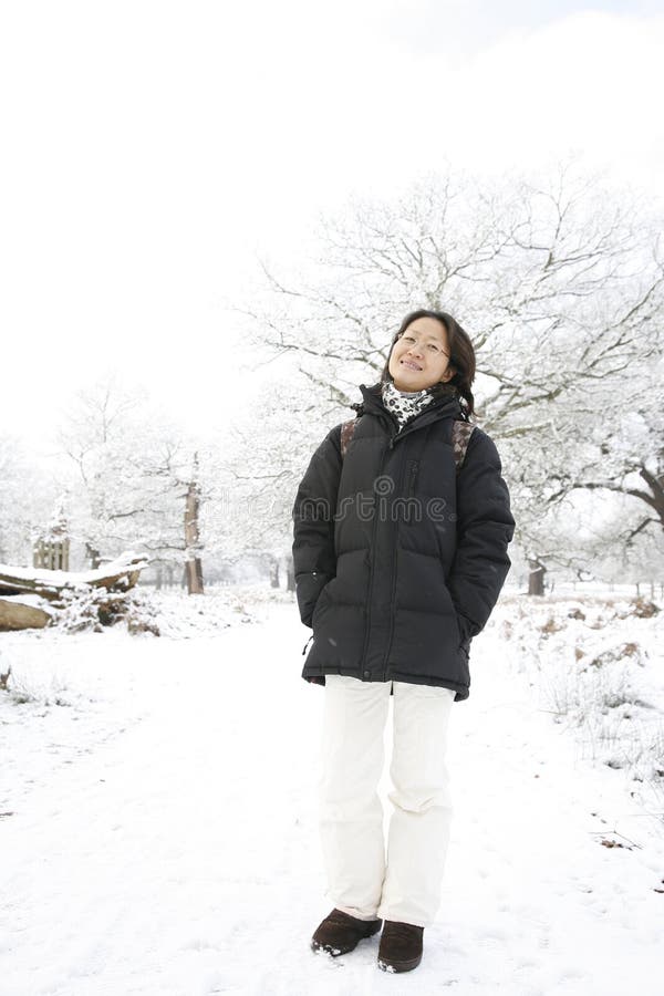 Smiling Asian Woman in Snow Covered Park Stock Image - Image of ...