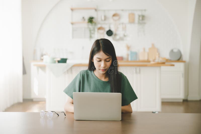 Smiling Asian Young Woman Working on Laptop at Home Office Stock Photo ...