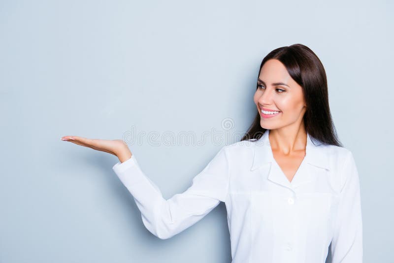 Smiling Assistant Holding Something on Hand and Demonstrating it Stock ...