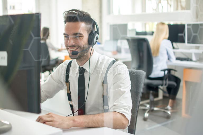 Smiling Assistant Using a Headset in a Call Center. Stock Image - Image ...