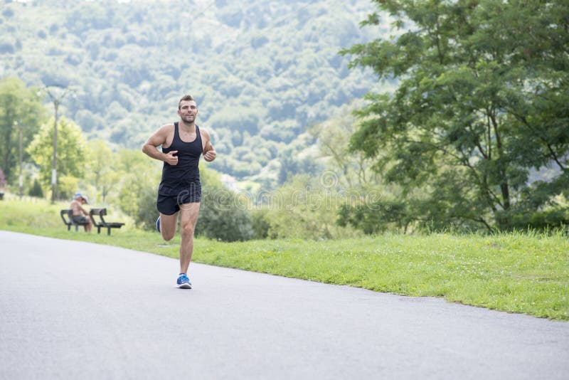 Smiling Athletic Man Running in the Park. Stock Photo - Image of male ...