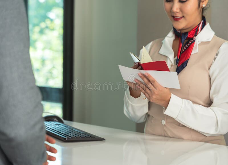 Smiling Attendant Working At Check In Desk In Airport Female Airline