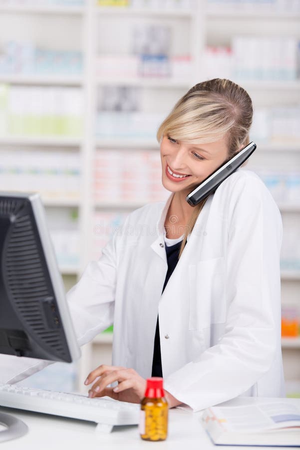 Smiling Attractive Pharmacist Talking at the Phone Stock Image - Image ...