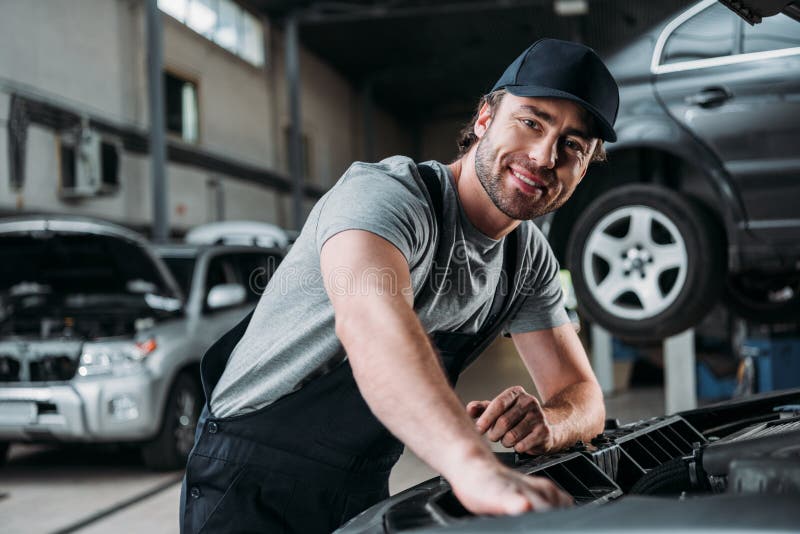 Smiling Auto Mechanic Working with Car Stock Image - Image of work ... Smiling Auto Mechanic Working with Car Stock Image - Image of work ...