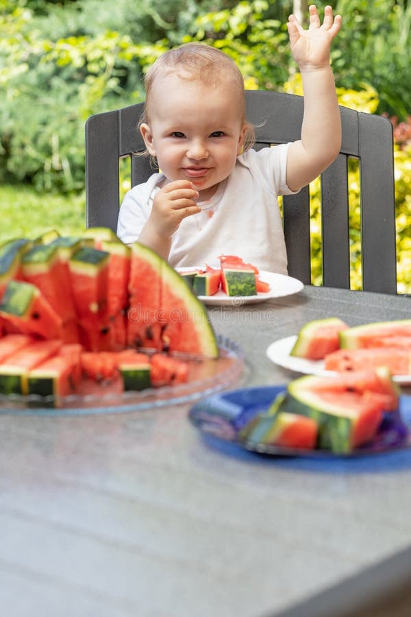 Smiling Baby Boy is Eating Watermelon Waving His Hand at the Camera ...