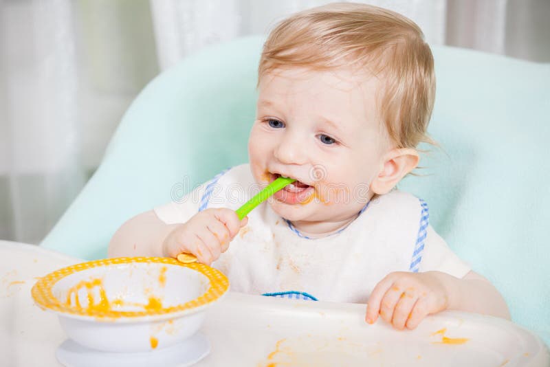 Smiling Baby Eating Food on Kitchen Stock Photo - Image of happy, house ...