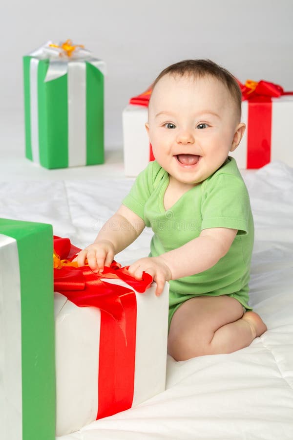 Smiling Baby Girl with a Gift Box on the Floor in Stock Image - Image ...