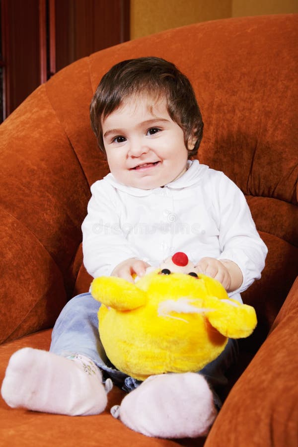 Smiling baby girl with toy stock image. Image of girl - 17100961