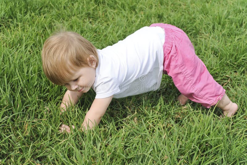 Smiling Baby Learning To Stand Up in Green Grass Stock Photo - Image of ...