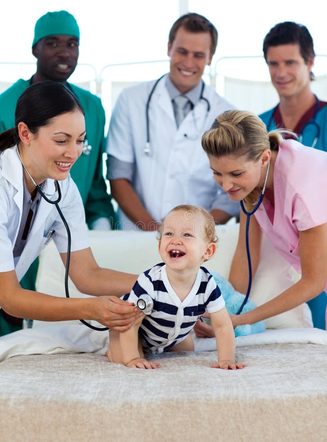 Smiling Baby with a Medical Team in Hospital Stock Photo - Image of ...