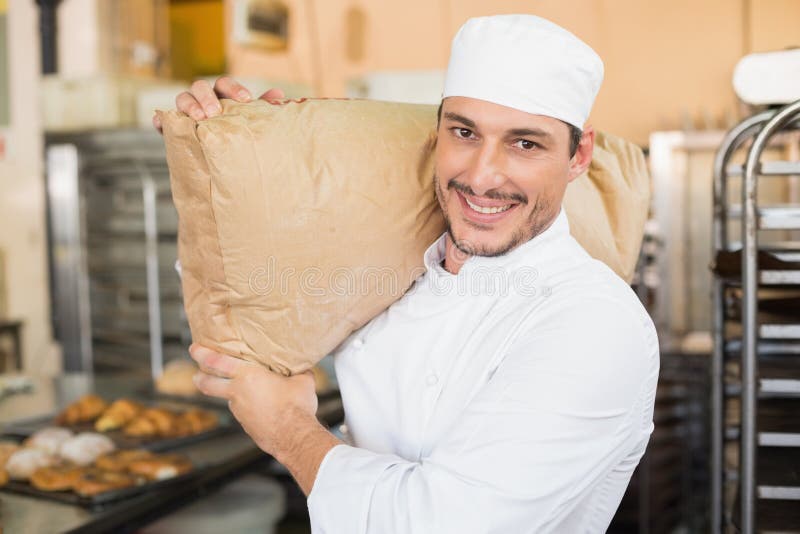 Smiling Baker Holding Bread Slices in Bakery Stock Photo - Image of ...