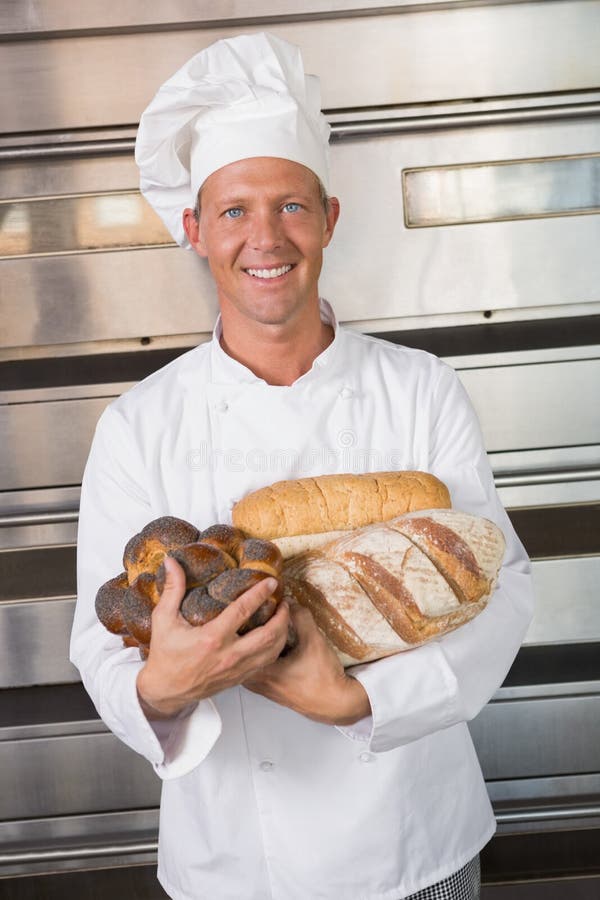 Smiling Baker Holding Fresh Loaves Stock Photo - Image of portrait ...