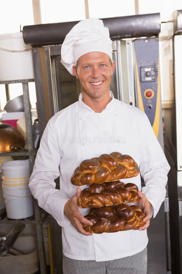 Smiling Baker Holding Fresh Loaves Stock Photo - Image of occupation ...
