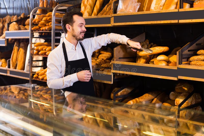 Baker Puts Baguettes and Bread on the Counter Stock Photo - Image of ...