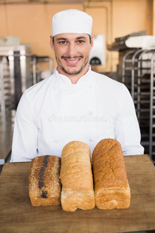 Smiling Baker Showing Loaves of Bread Stock Photo - Image of adult ...