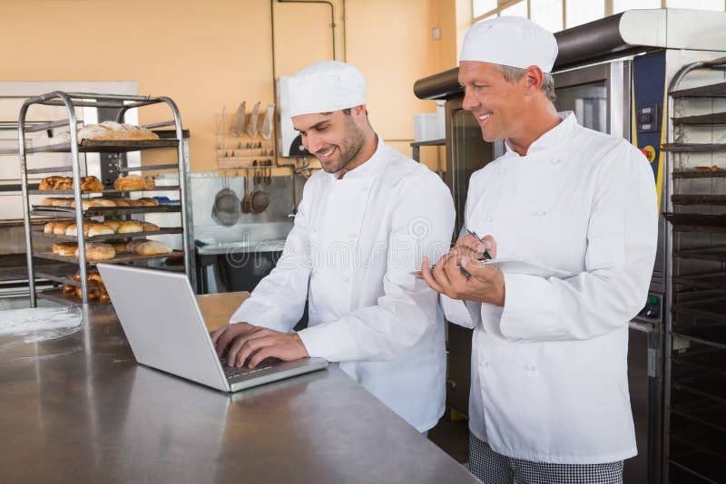 Smiling Bakers Working Together on Laptop Stock Photo - Image of bakery ...