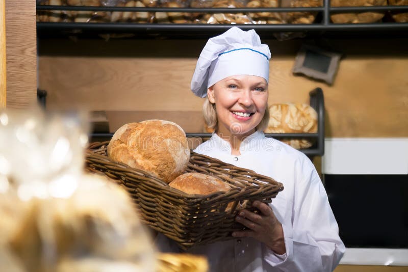 Smiling Bakery Employee Offering Bread Stock Image - Image of bread ...
