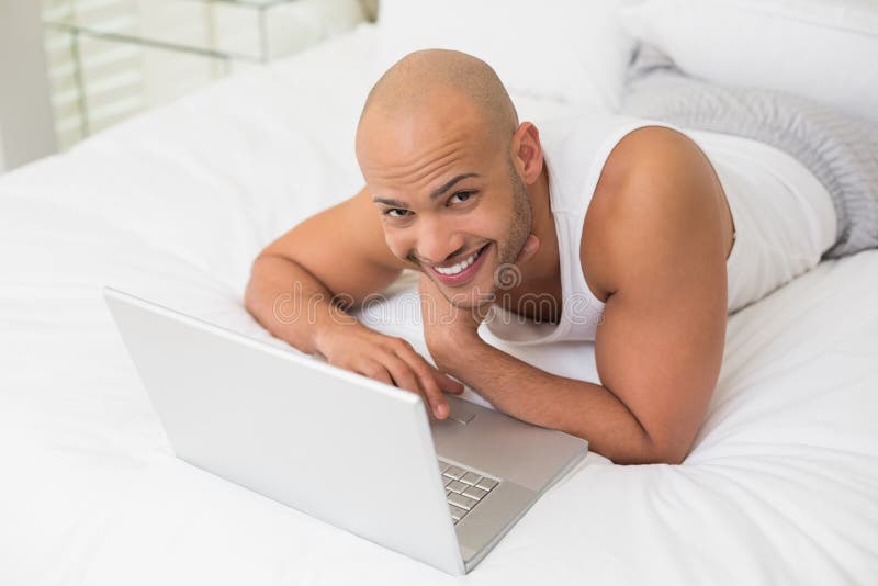 Smiling Bald Man Using Laptop in Bed Stock Image - Image of technology ...