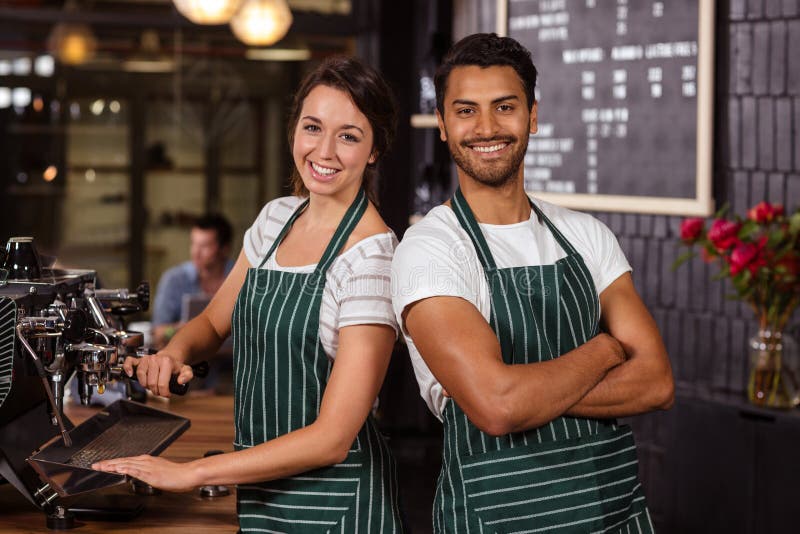 Smiling baristas working stock photo. Image of crosssed - 66984448