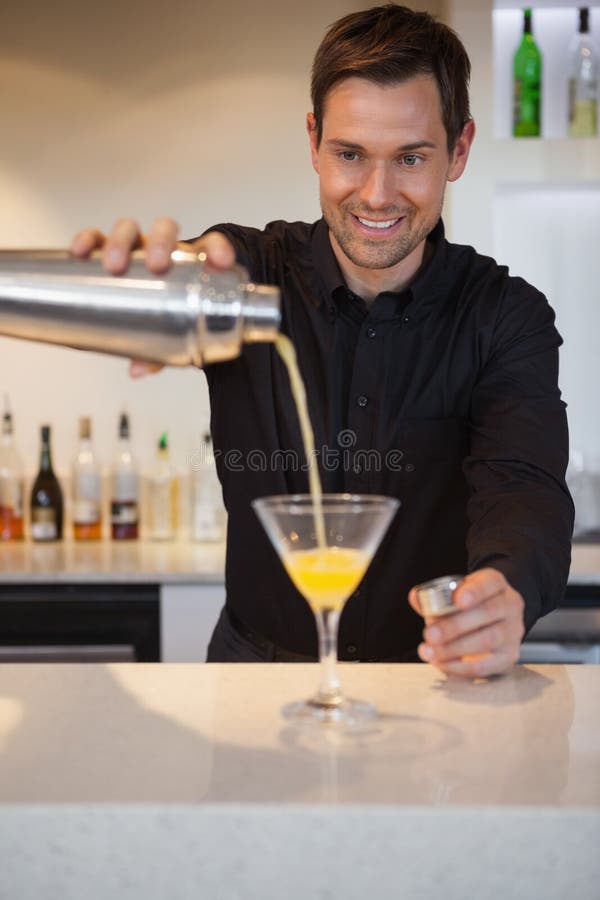 Smiling Bartender Pouring Cocktail into Glass Stock Photo - Image of ...