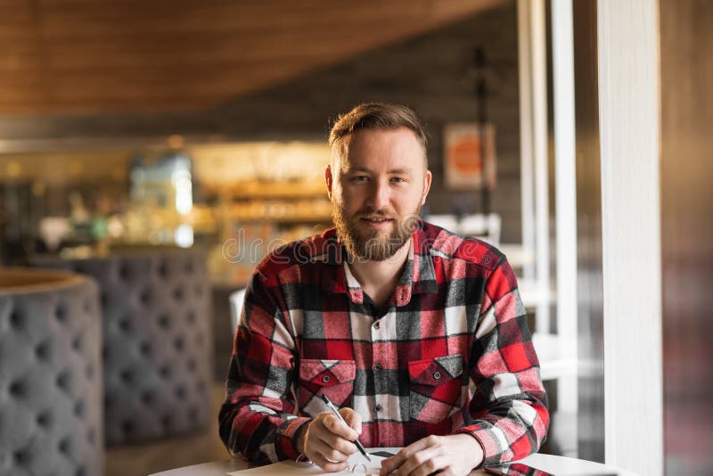 Smiling Bearded Cafe Owner Planning Work. Male Restaurant Chef Sits at ...